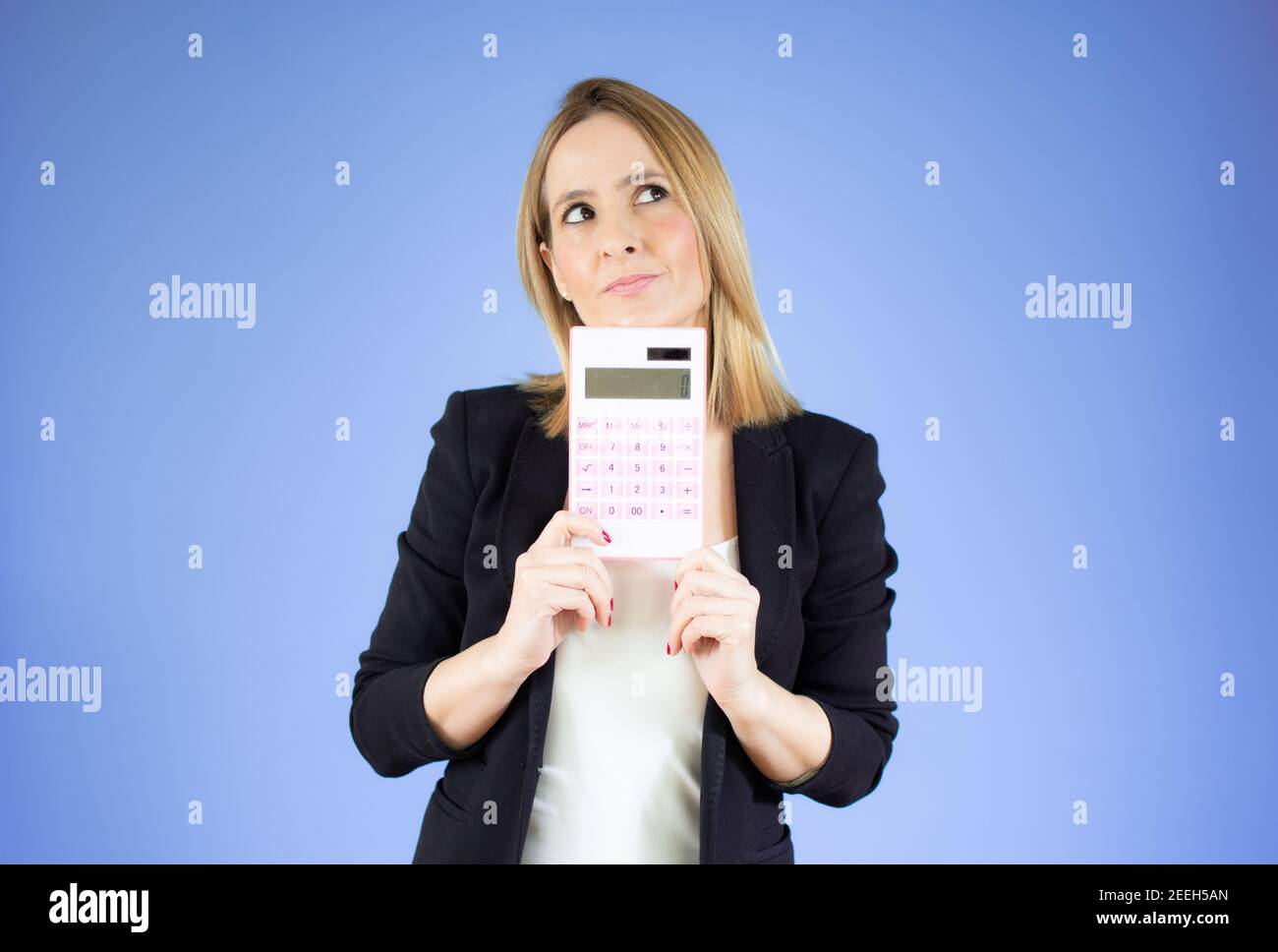 Young business woman hold digital calculator over purple background ...