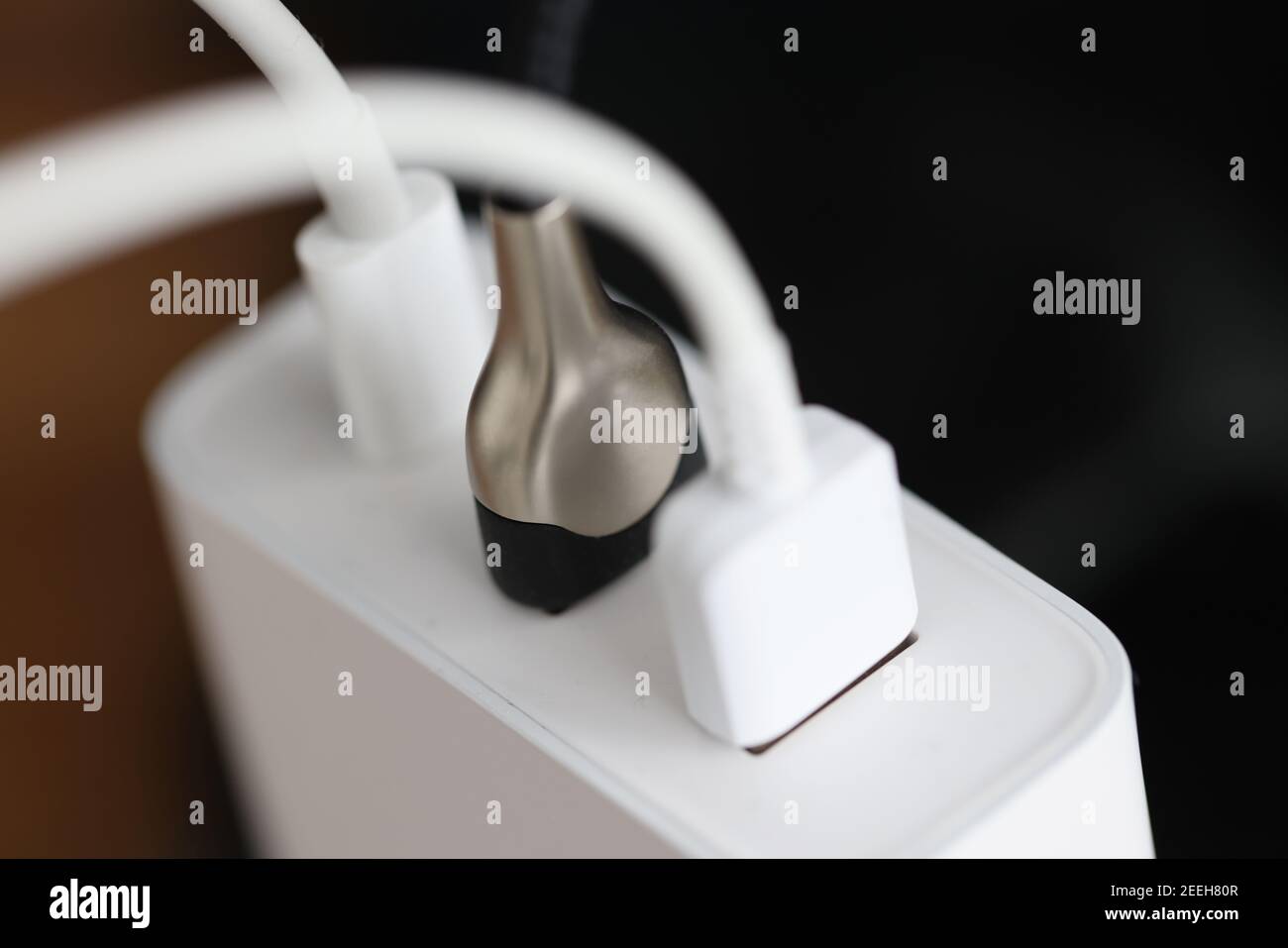 White usb cable is plugging into socket closeup Stock Photo - Alamy