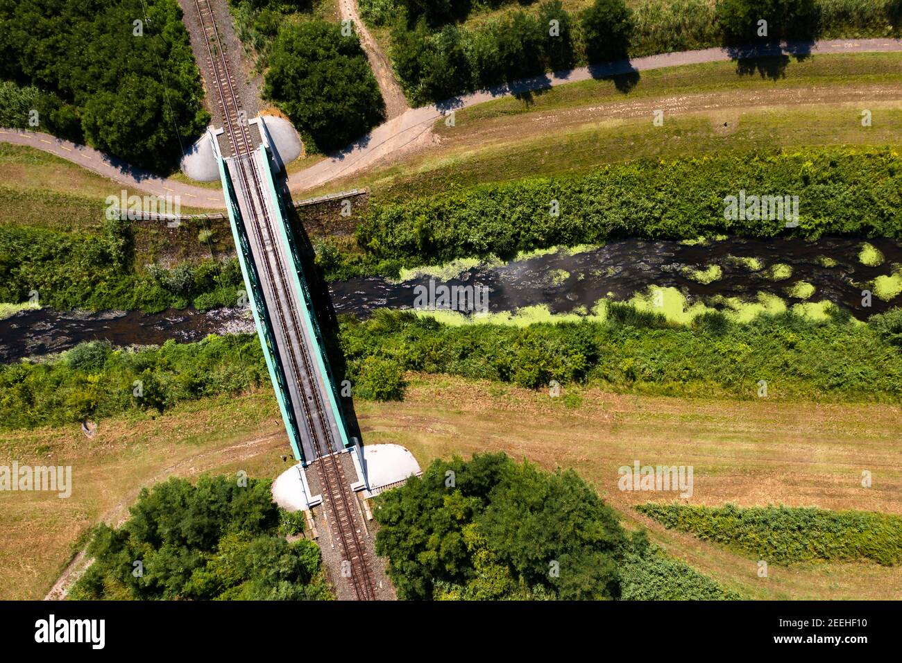 Railway line over the brook with bridge. Aerial railway line and green ...
