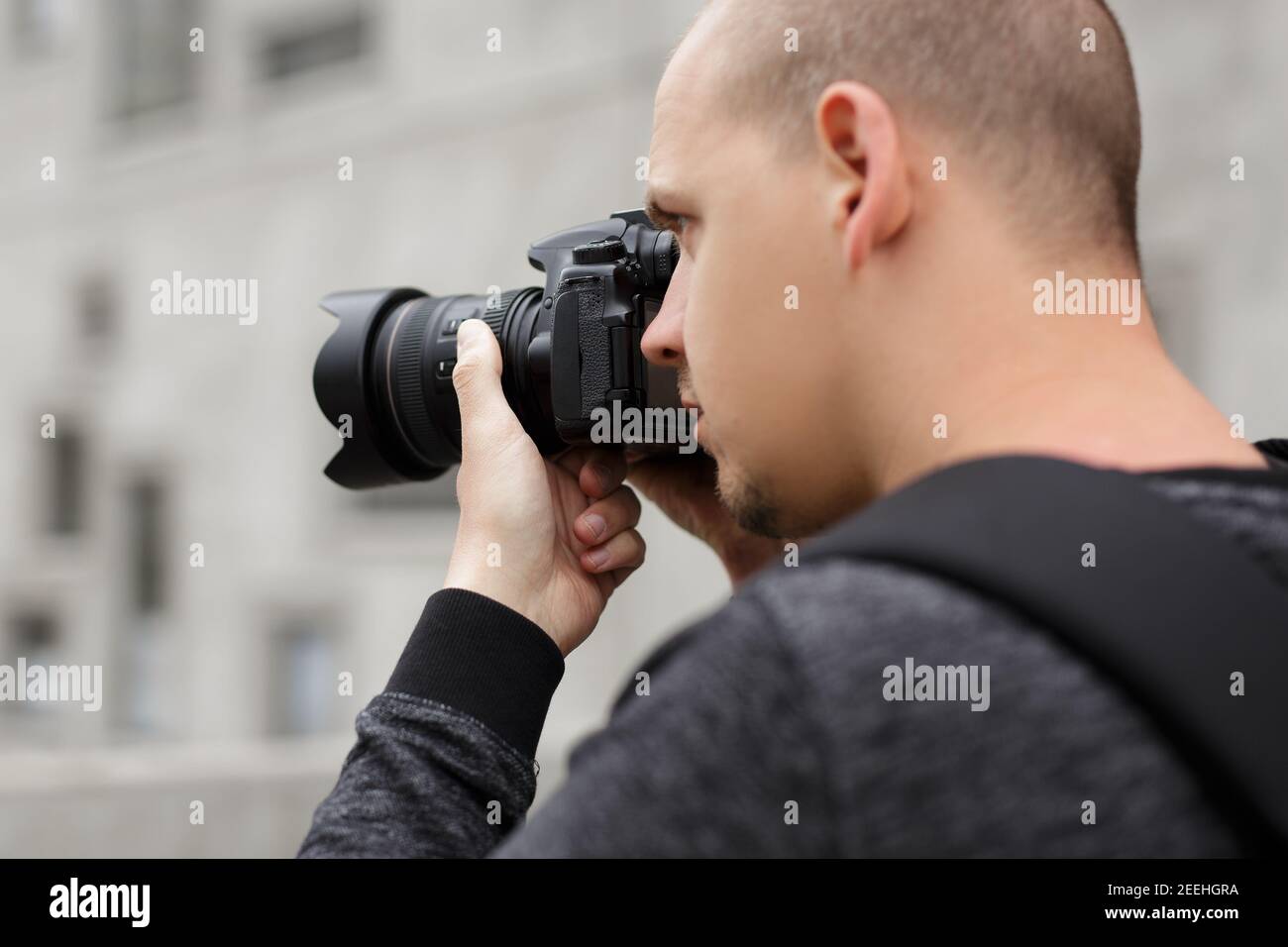 photography and hobby concept - close up back view of male photographer ...