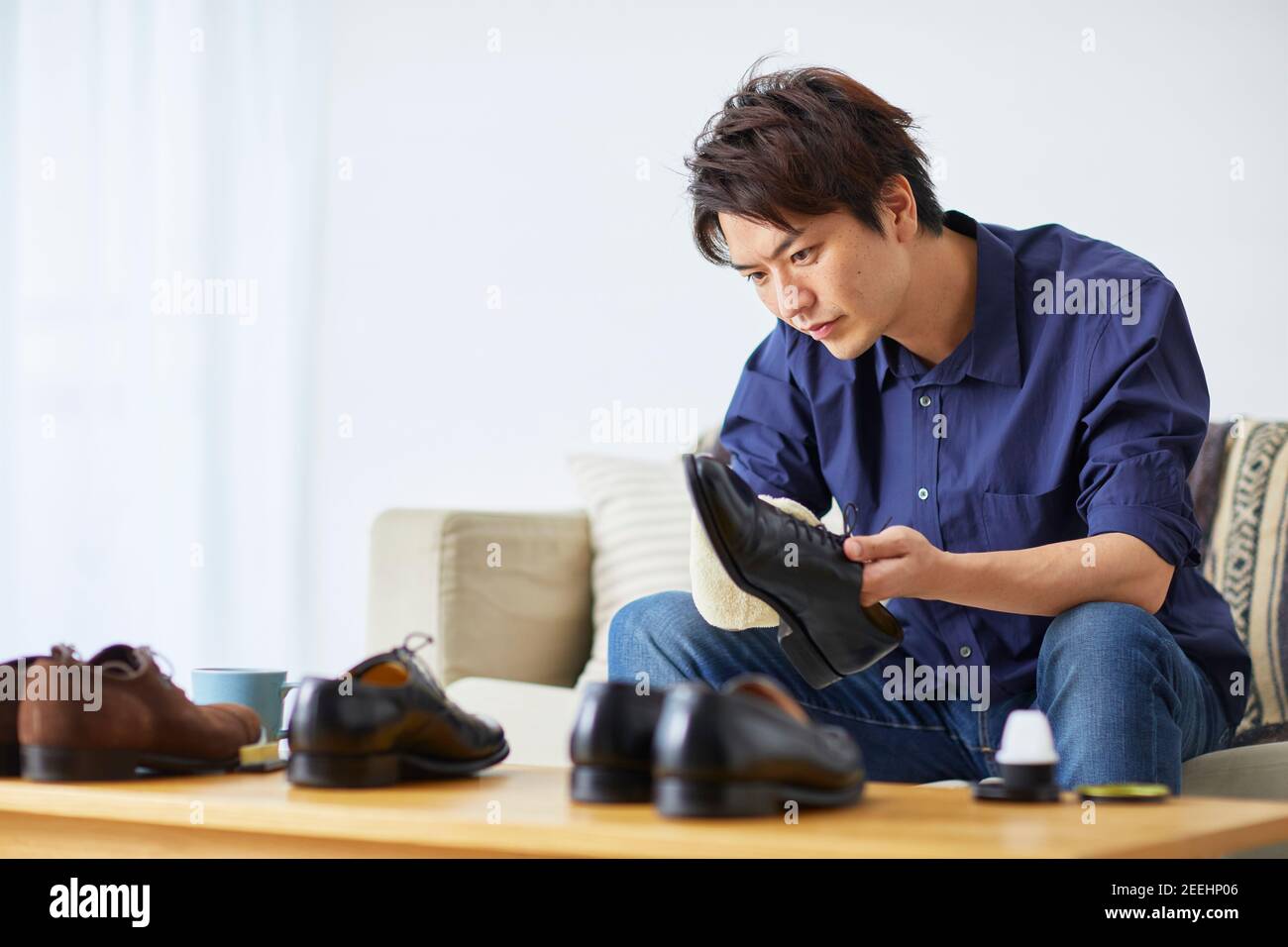 Japanese man cleaning shoes at home Stock Photo - Alamy