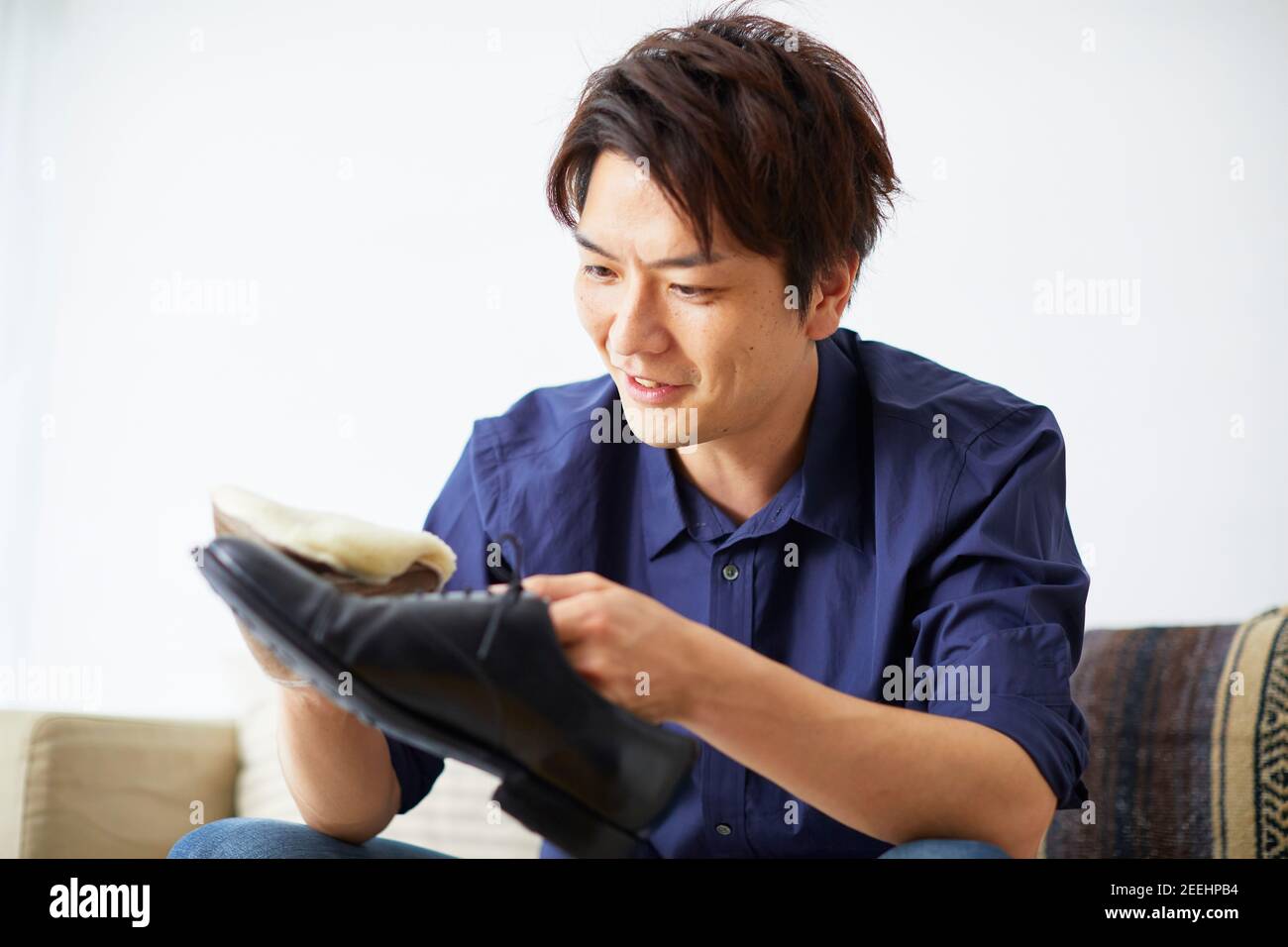 Man cleaning shoes hi-res stock photography and images - Alamy