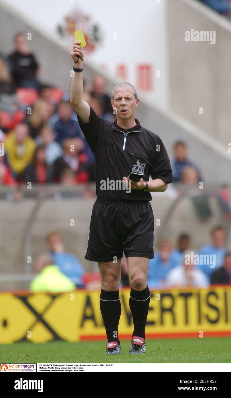 Referee neale barry shows yellow card hi-res stock photography and ...