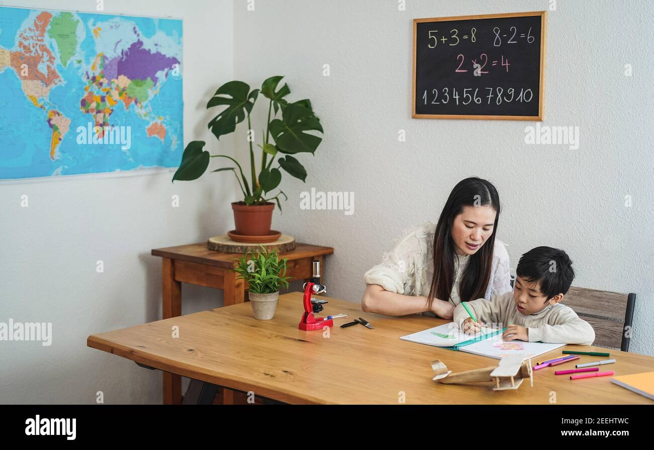 Asian teacher working with child boy at preschool - Focus on faces ...