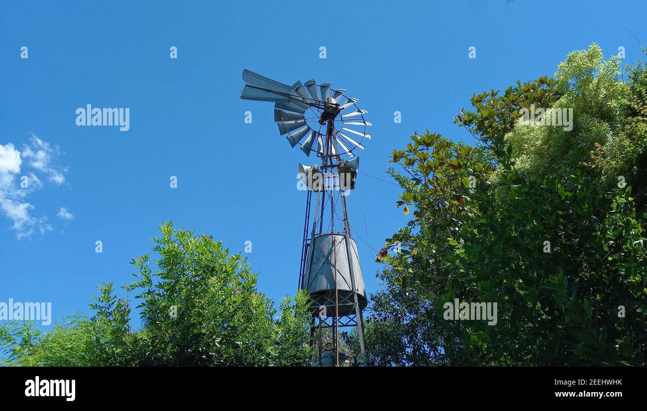 low angle shot of a traditional rural windmill in for pumping water in ...