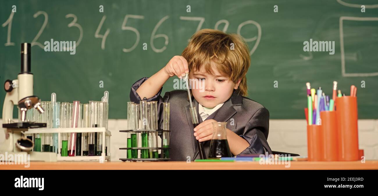 science experiments with microscope in lab. biology. Little boy is ...