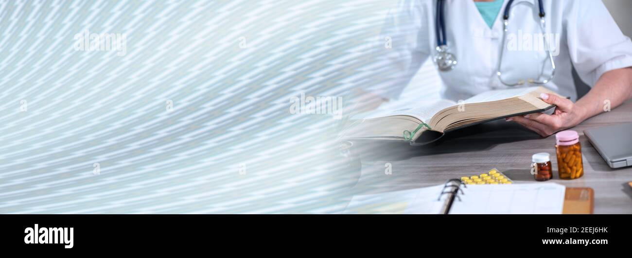 Female doctor reading a textbook in medical office; panoramic banner ...