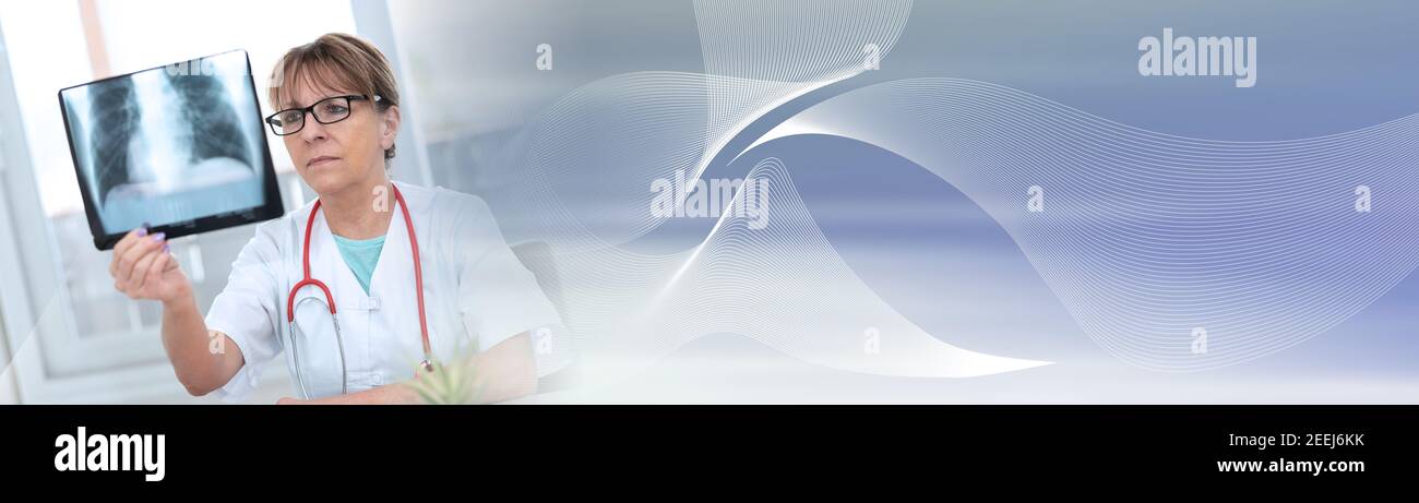 Female doctor looking at x-ray in clinic; panoramic banner Stock Photo ...