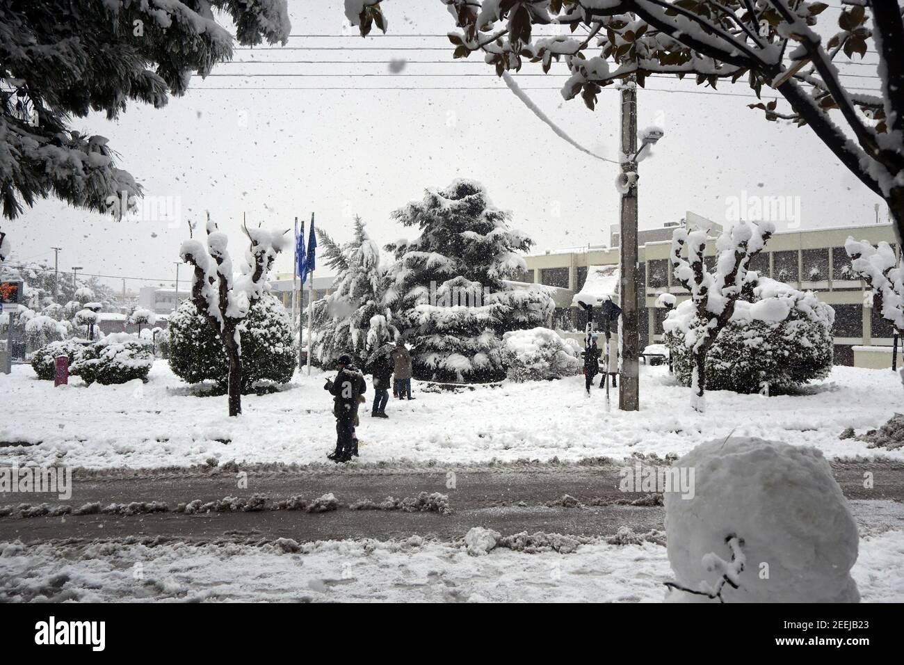 Athens, Greece. 16th Feb., 2021. People walk in a street covered in ...