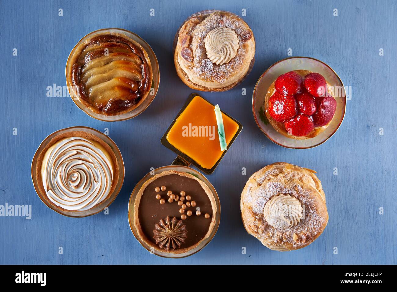 A variety of French desserts shot flat lay on blue wooden board Stock ...