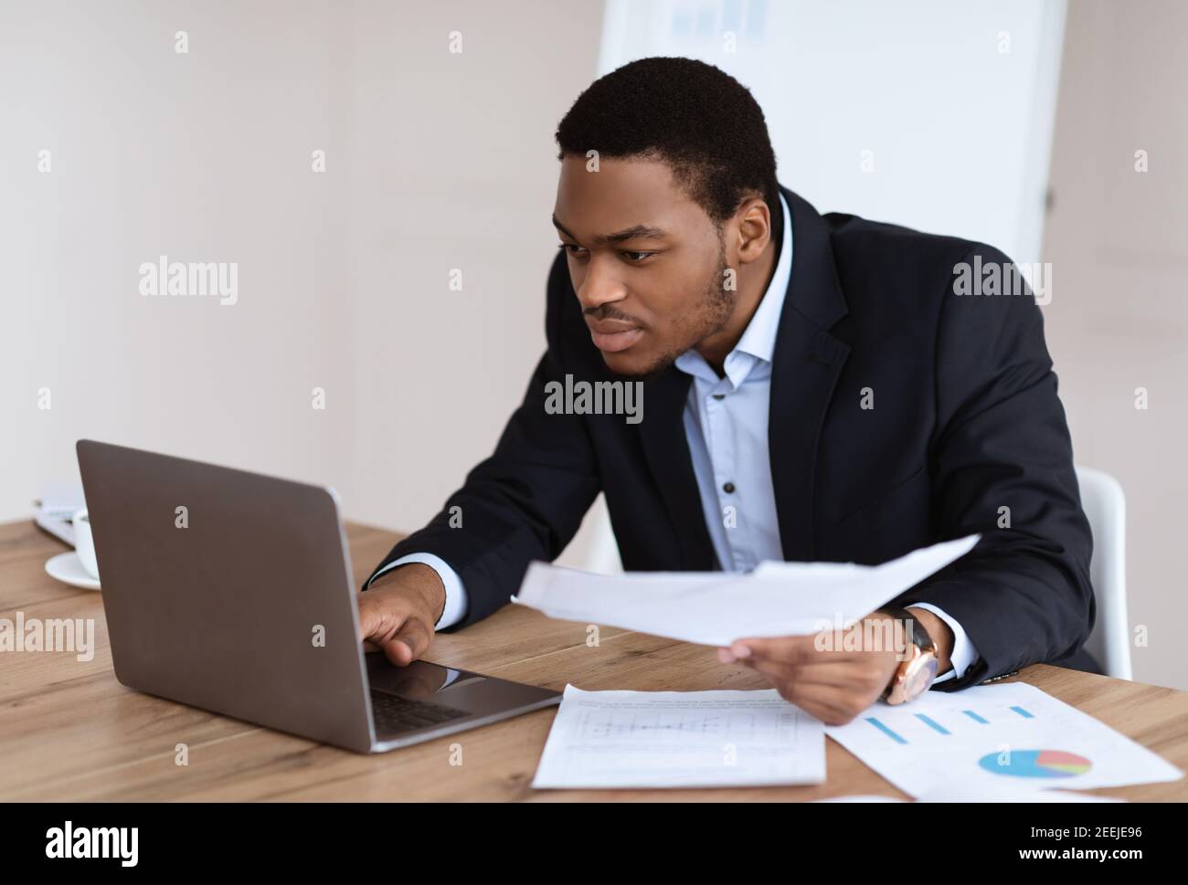 African american manager checking marketing report, using laptop Stock ...