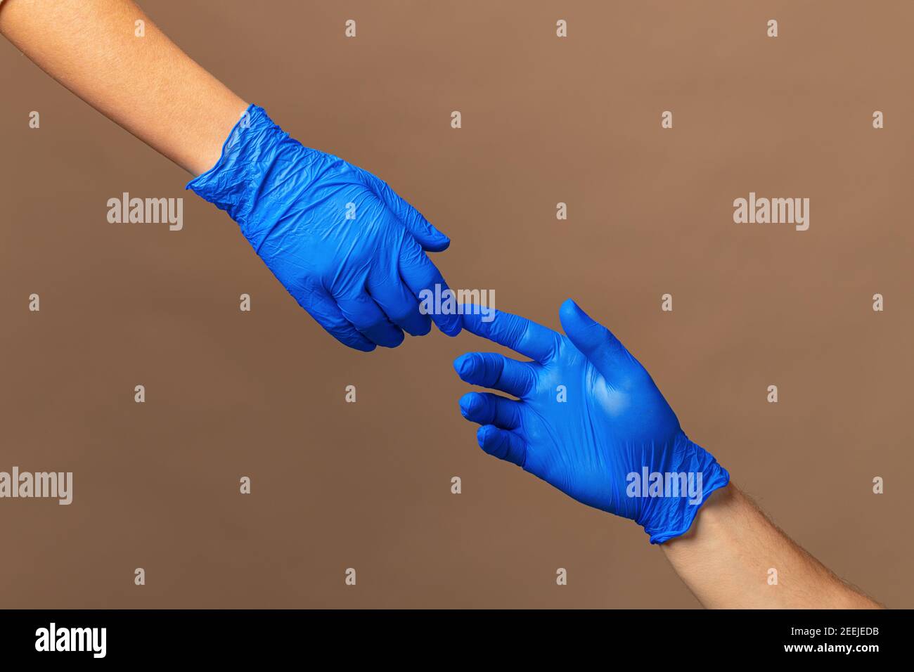 Male and female hands in medical gloves stretch to each other. Help ...
