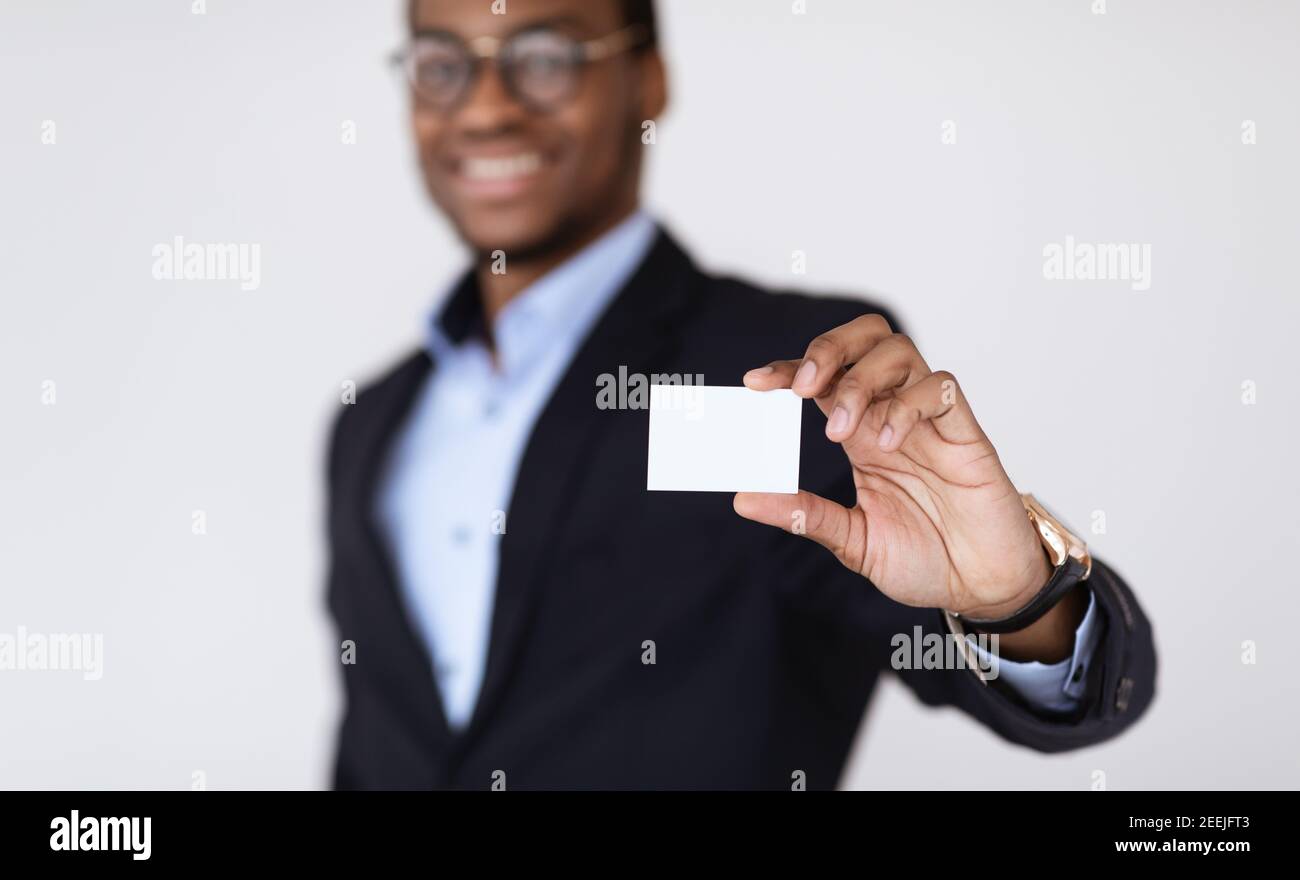 Black businessman holding blank card for clients Stock Photo - Alamy