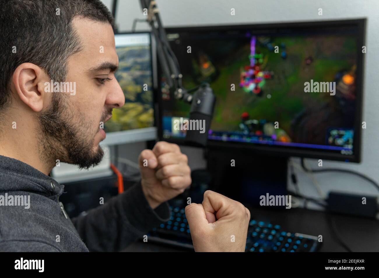 Latino boy making a victory gesture for having won a computer game ...