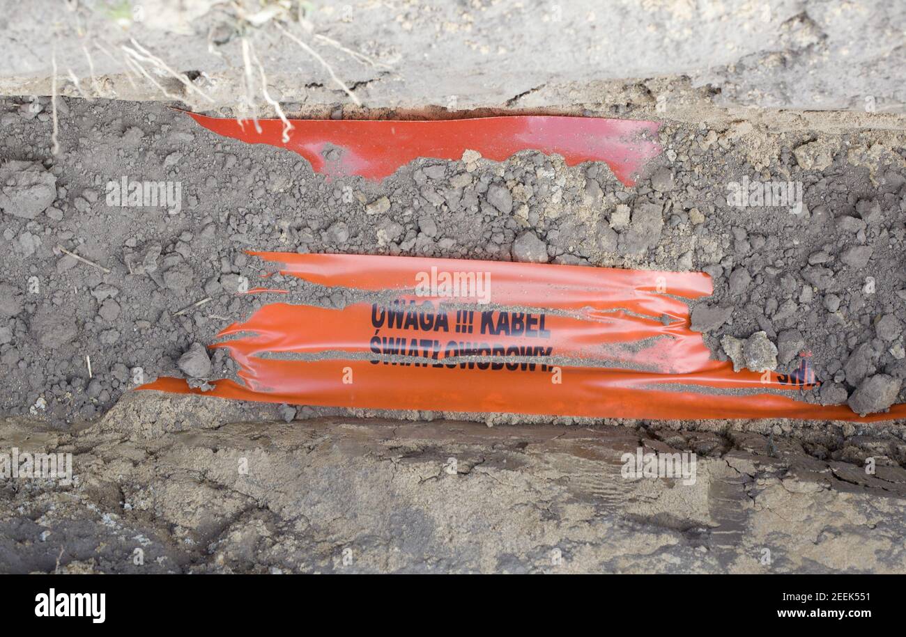 Red warning tape for fiber optic cables on a construction site Stock ...