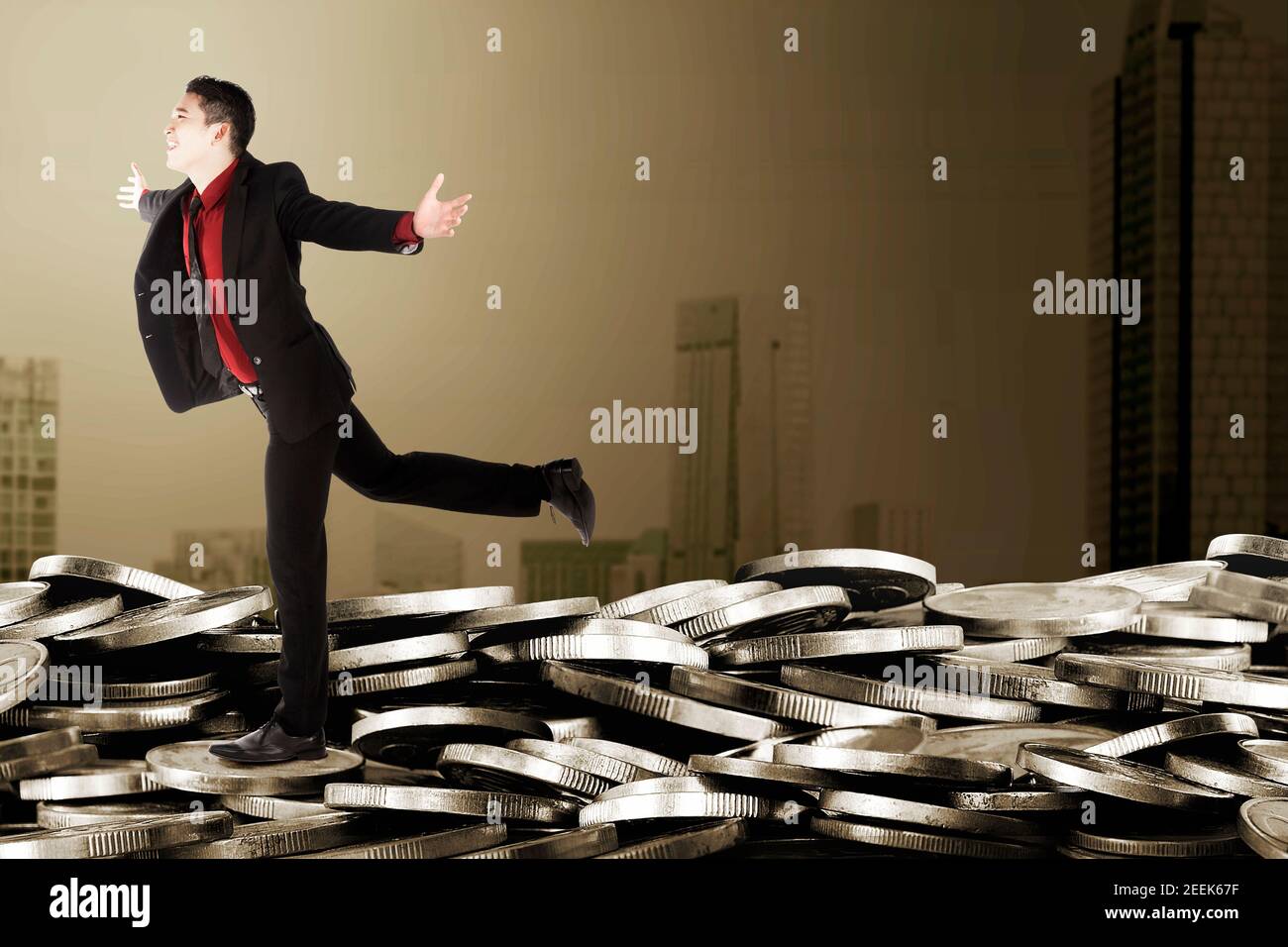 Asian businessman running with coin stack background Stock Photo - Alamy