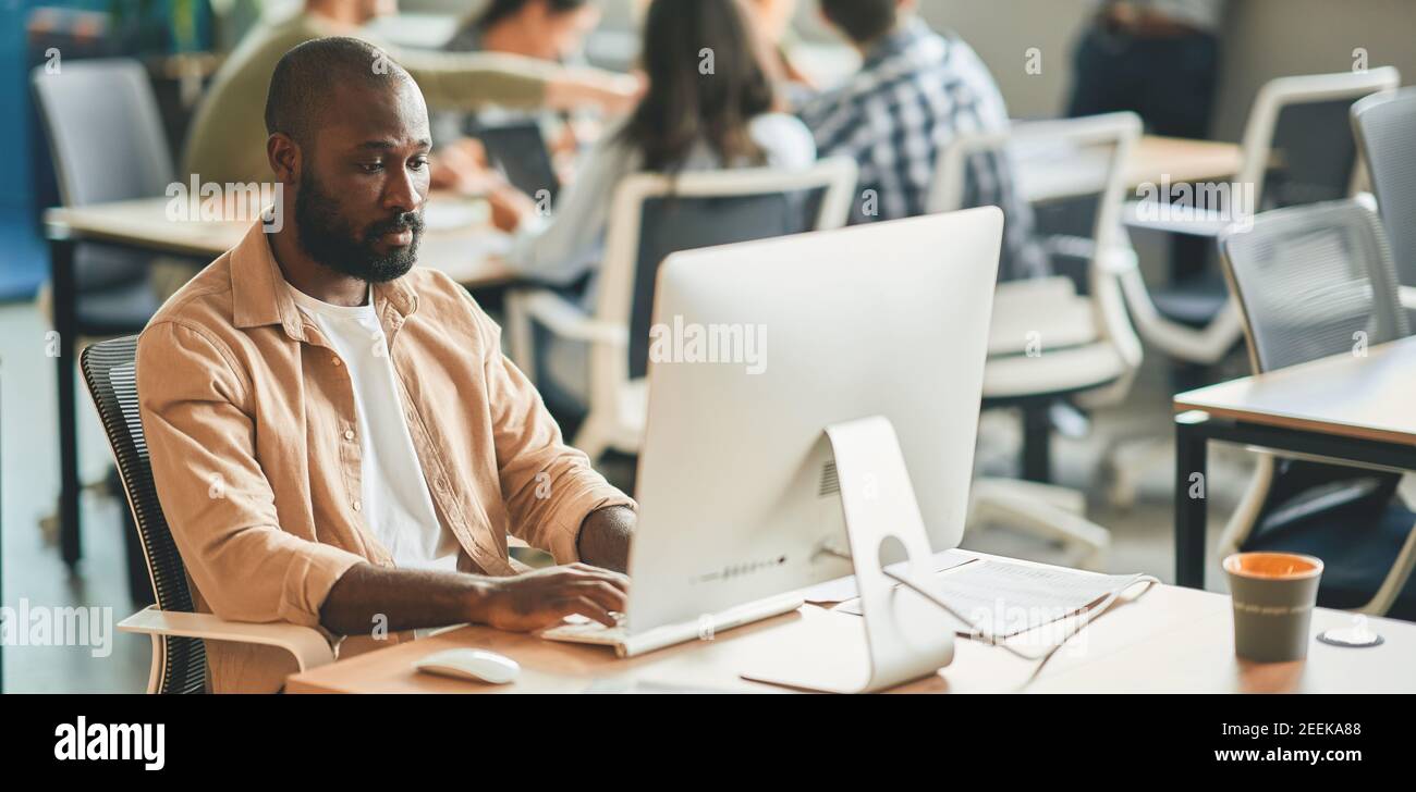 Dedicated man being productive at his office Stock Photo - Alamy