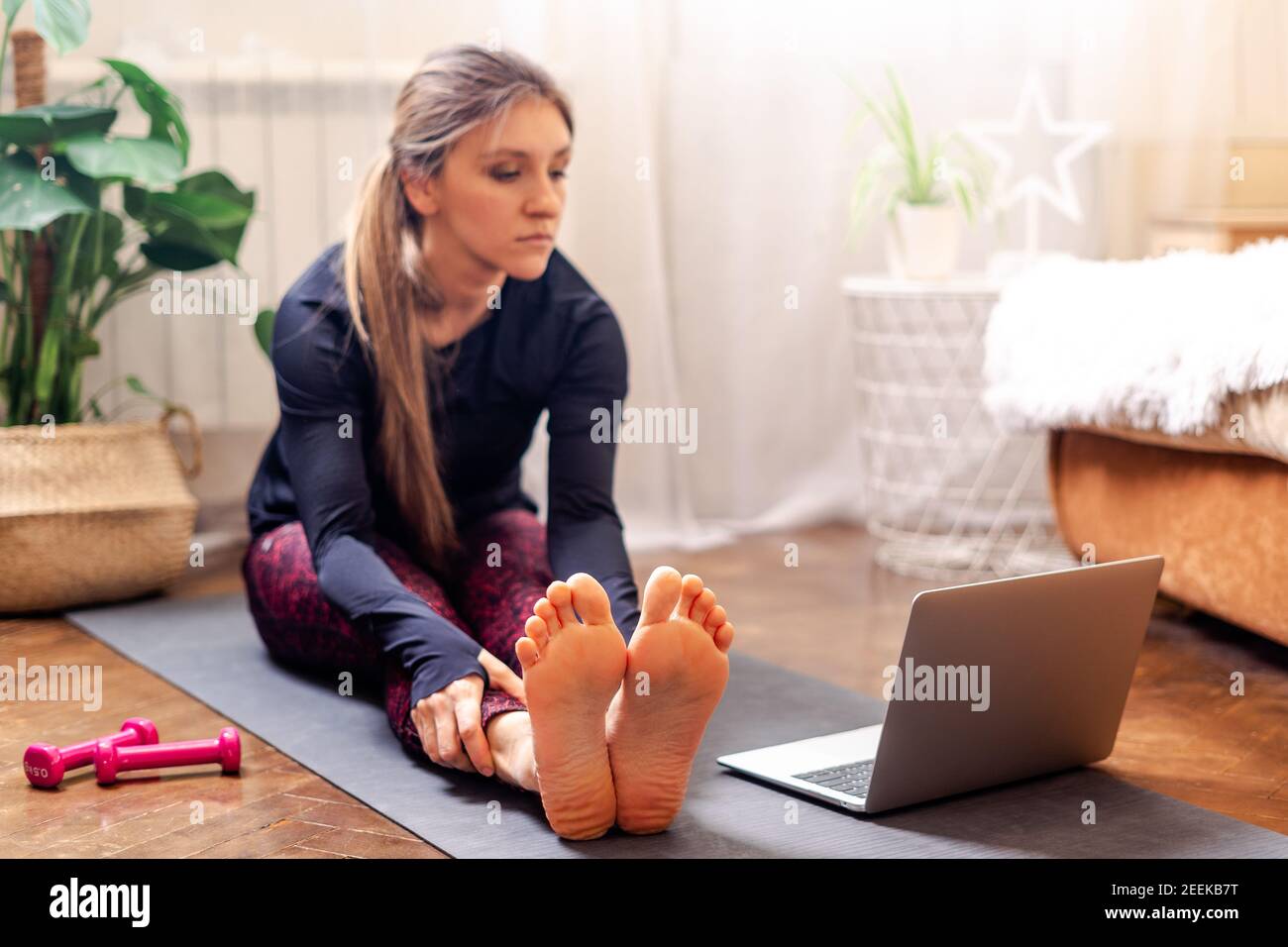 Woman doing stretching exercise at home Stock Photo - Alamy