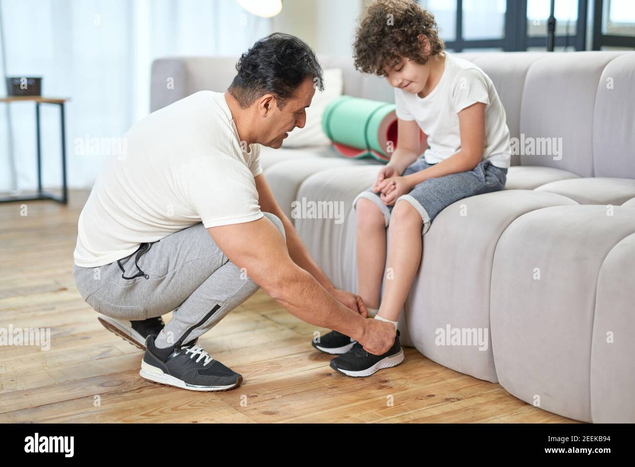 Child on father leg hi-res stock photography and images - Alamy