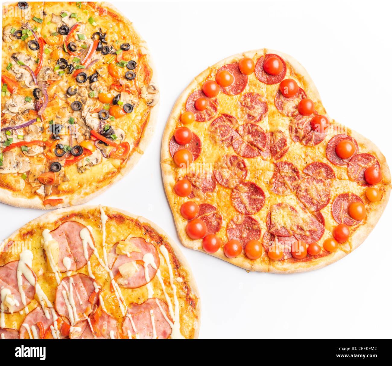 three different kinds of pizzas, around and heart shaped on white ...