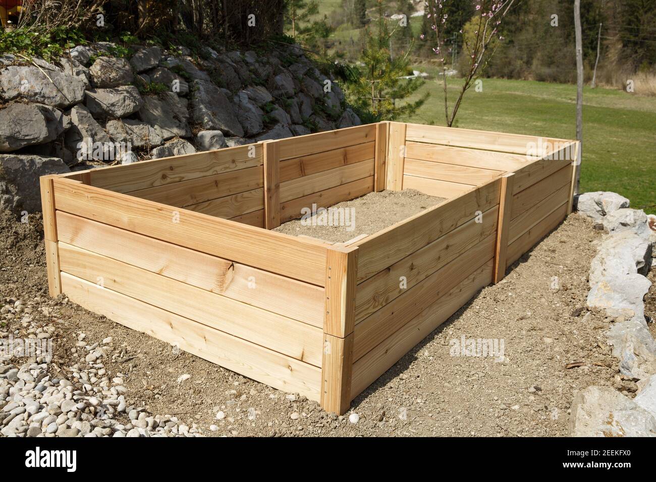 New wooden frame for a raised garden bed. DIY concept. Sustainable ...
