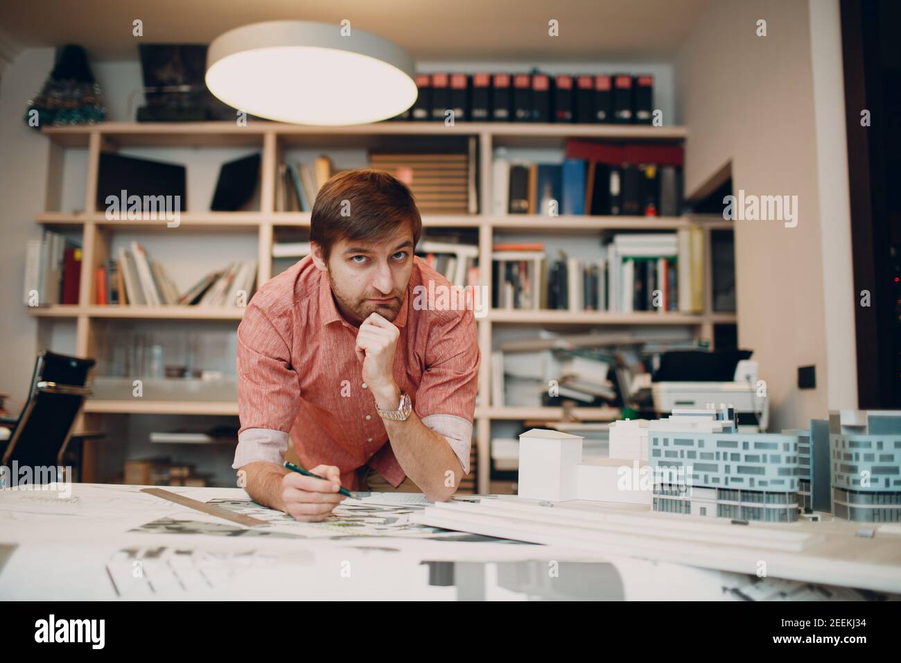 Architect with blueprints and layout design project at office bureau ...