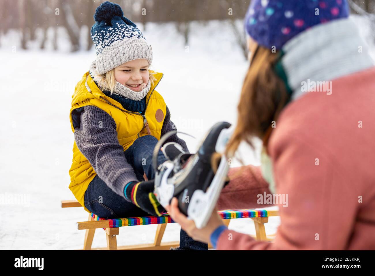 Mother helping son to put on his ice skates Stock Photo - Alamy Mother helping son to put on his ice skates Stock Photo - Alamy