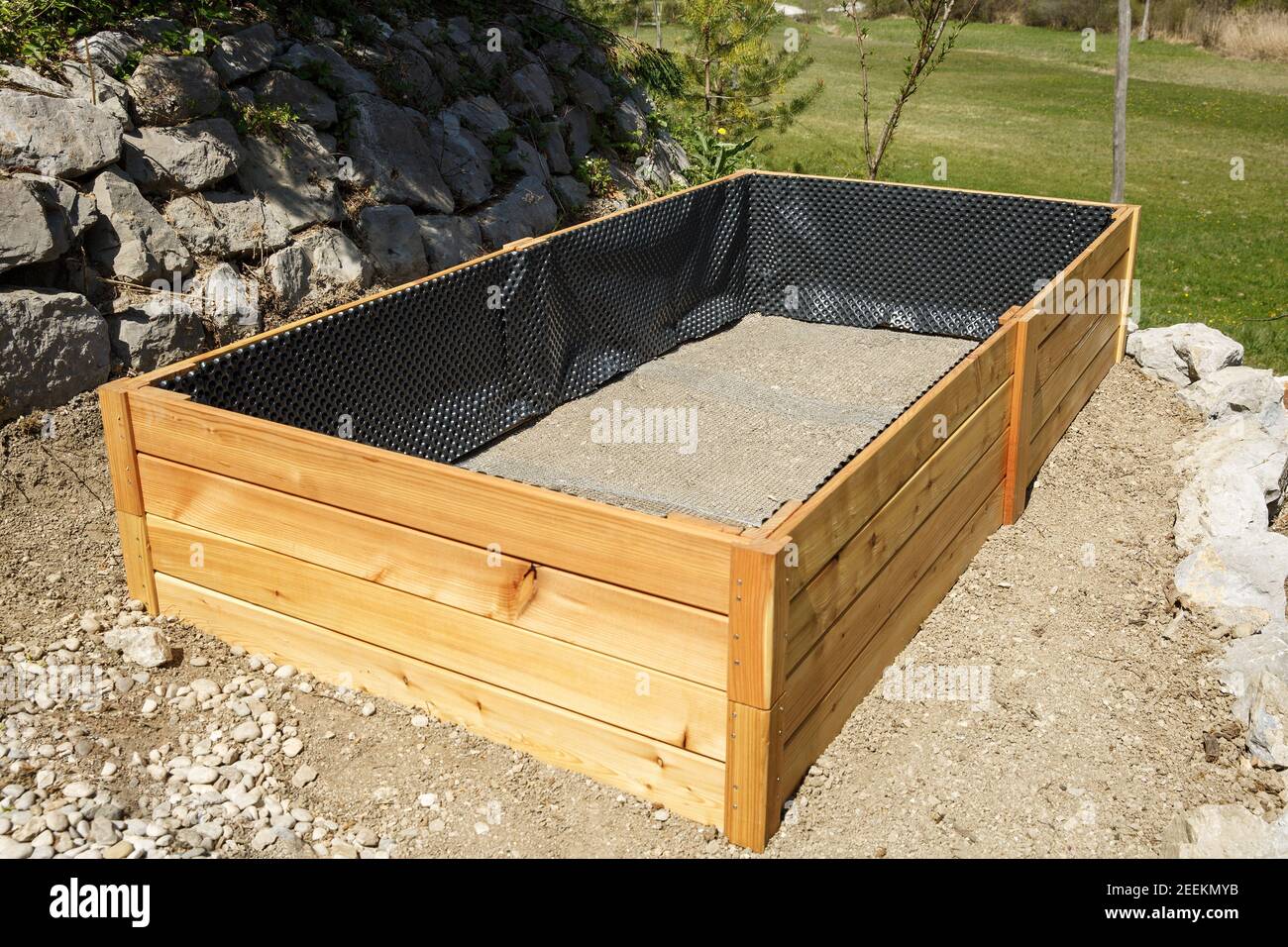 Building new wooden frame for a raised garden bed. DIY concept ...