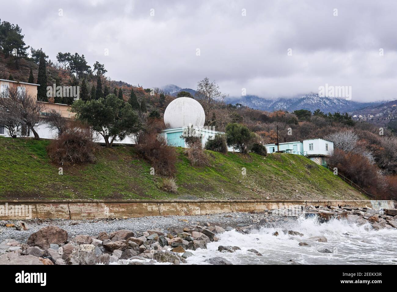 small observatory with a white geodesic dome on the seashore against ...