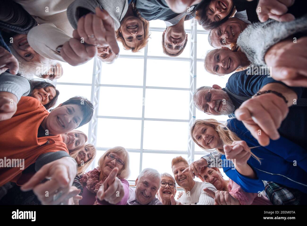 Group of smiling people pointing at the camera Stock Photo - Alamy