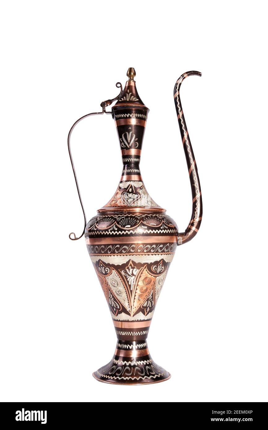 Copper jug with a traditional Arabic ornaments on a white background ...