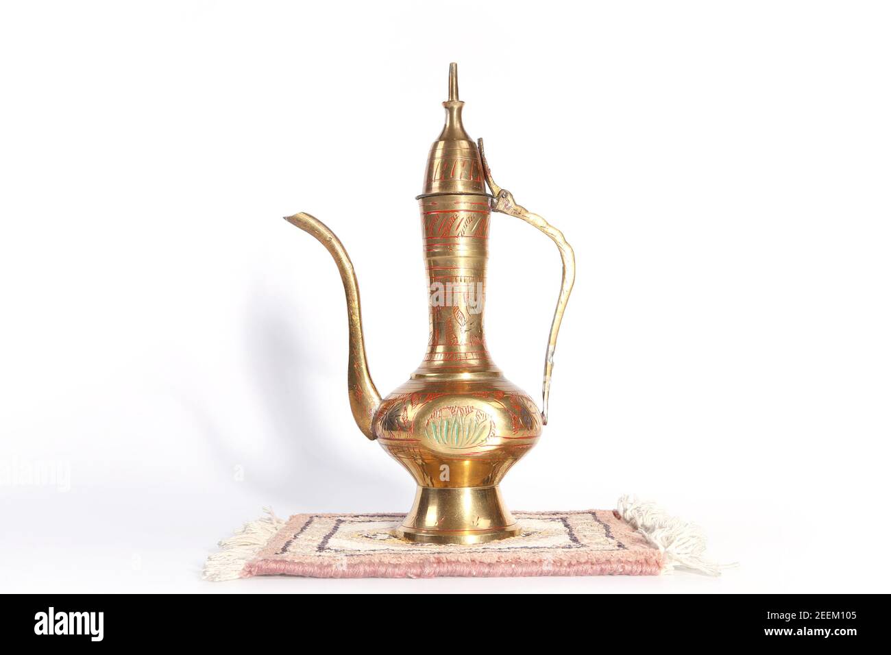 Copper jug with a traditional Arabic ornaments on a white background ...