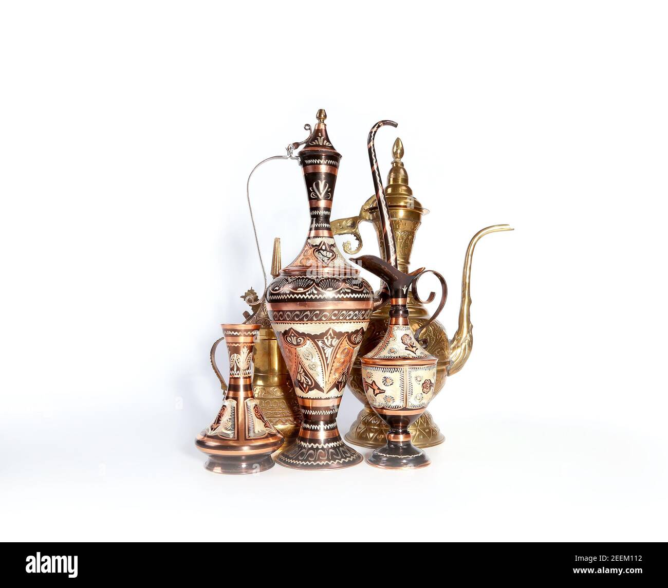 Copper jug with a traditional Arabic ornaments on a white background ...