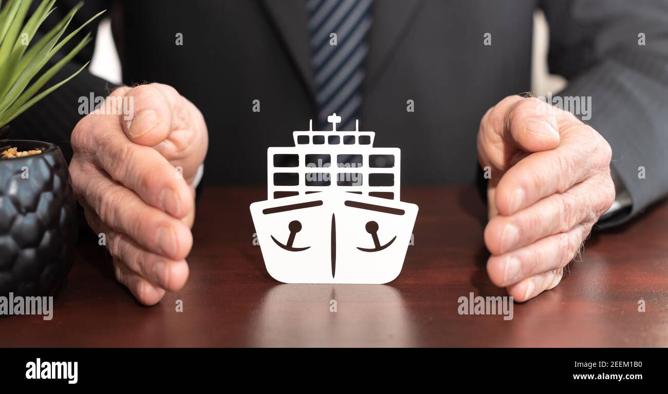 Insurer protecting a cargo ship with his hands Stock Photo - Alamy