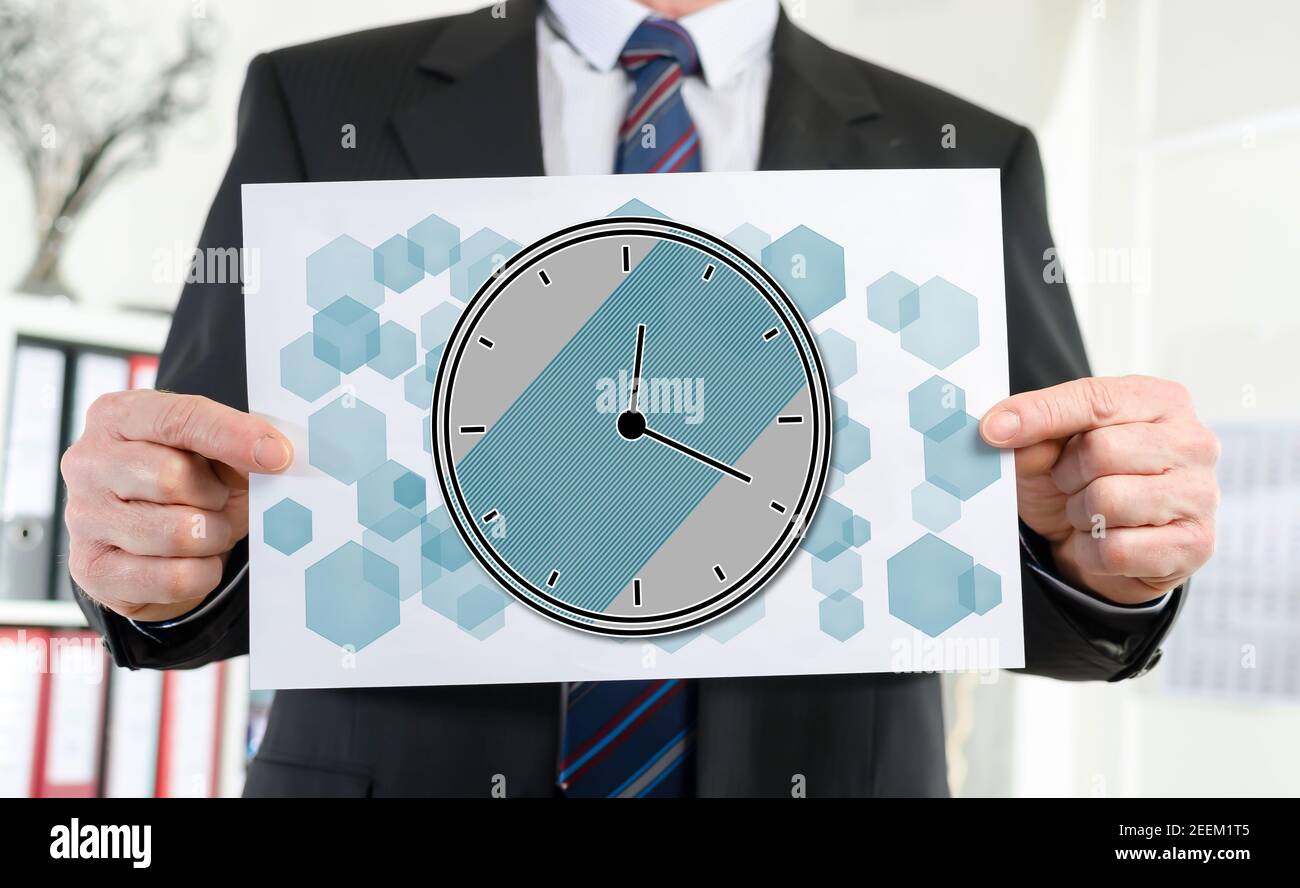 Paper showing time management concept held by a businessman Stock Photo ...
