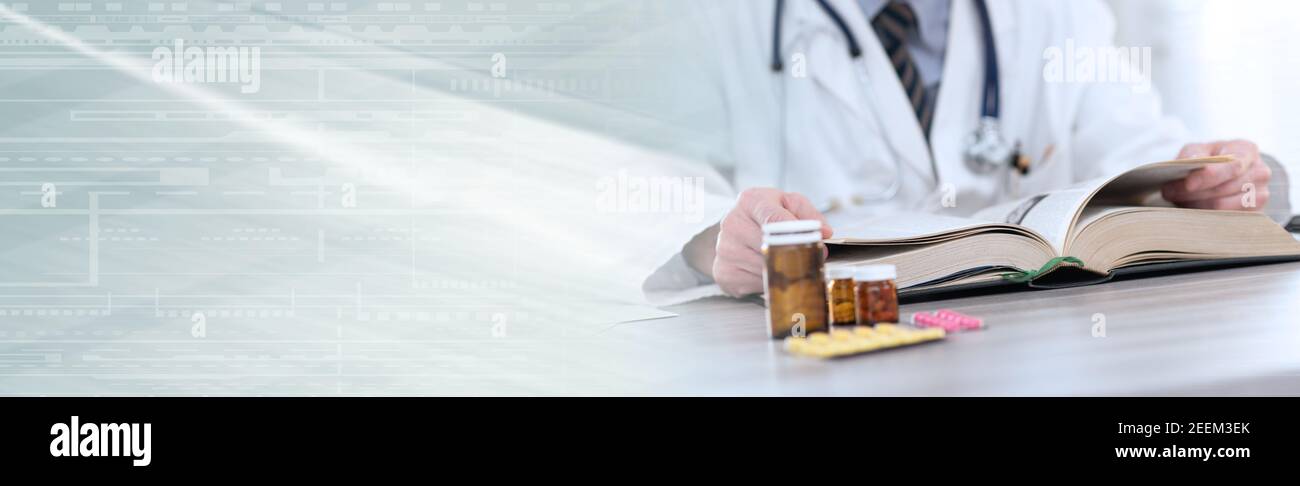 Doctor reading a textbook in medical office; panoramic banner Stock ...