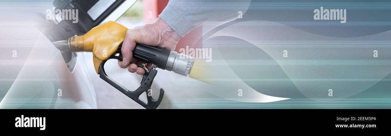 Hand holding yellow fuel pump nozzle and refilling car; panoramic ...