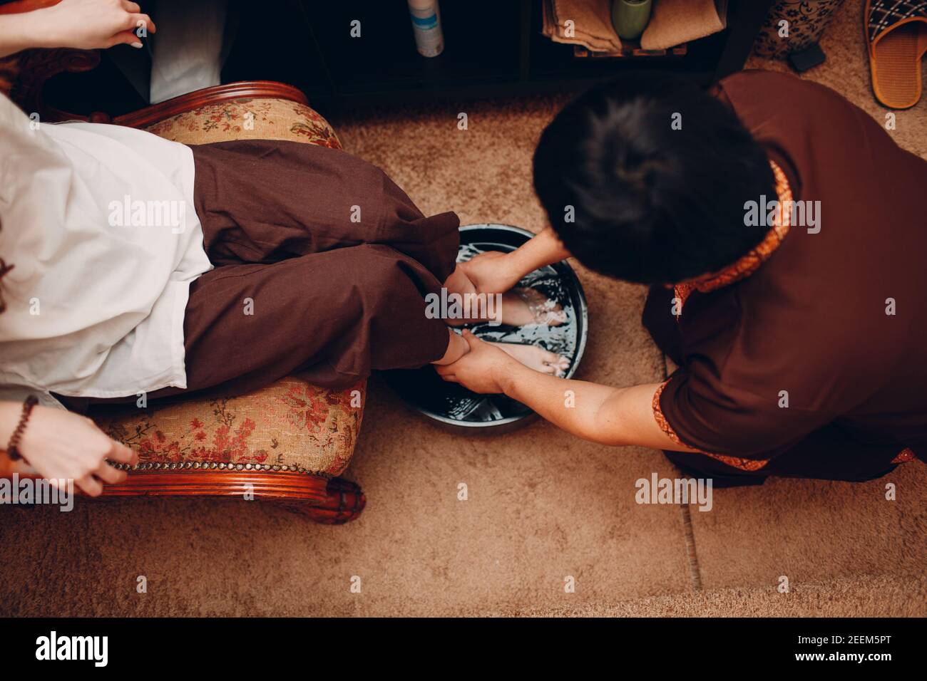 Thai man washing feet legs and making classical thai massage procedure ...