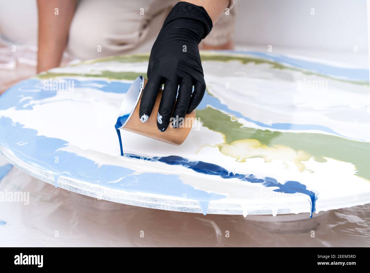 Artistic background. Round canvas with dripping paint. The process of ...