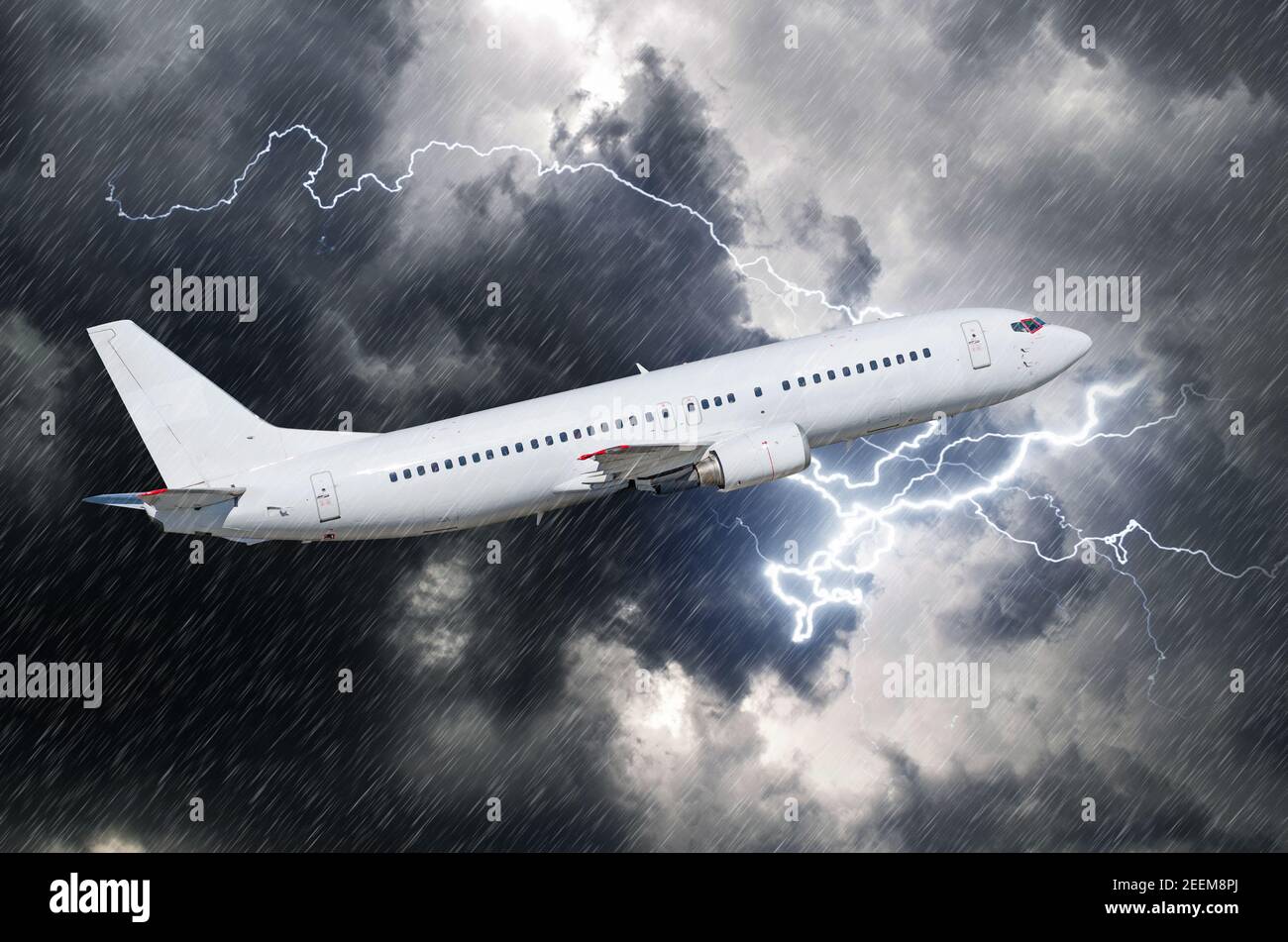 White passenger airplane takes off during a thunderstorm of rain, bad ...