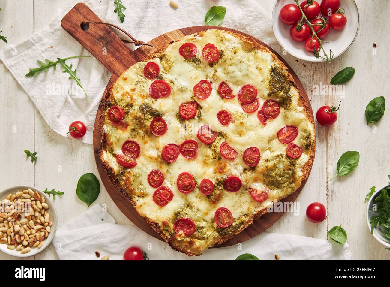 Top view of a delicious pizza with salmon and pesto topped with melted ...