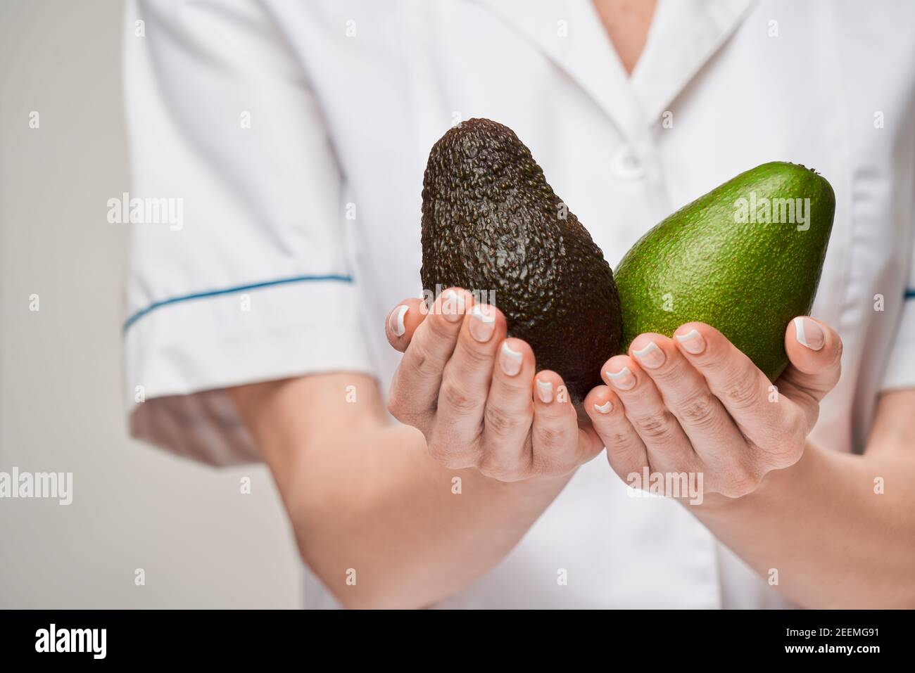 nutritionist doctor healthy lifestyle concept - holding organic avocado ...