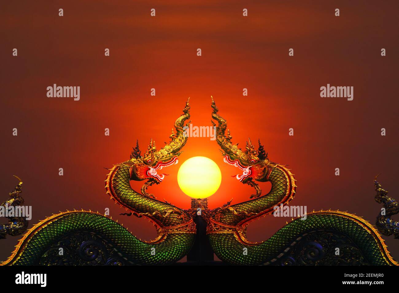 Two Naga status and pole in middle and sunset dark red sky on top of ...