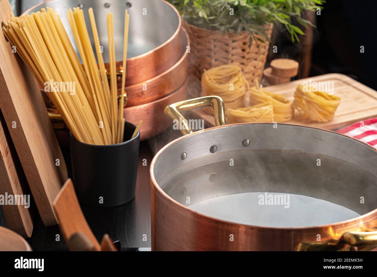 Copper pot with boiling water on a gas stove Stock Photo - Alamy