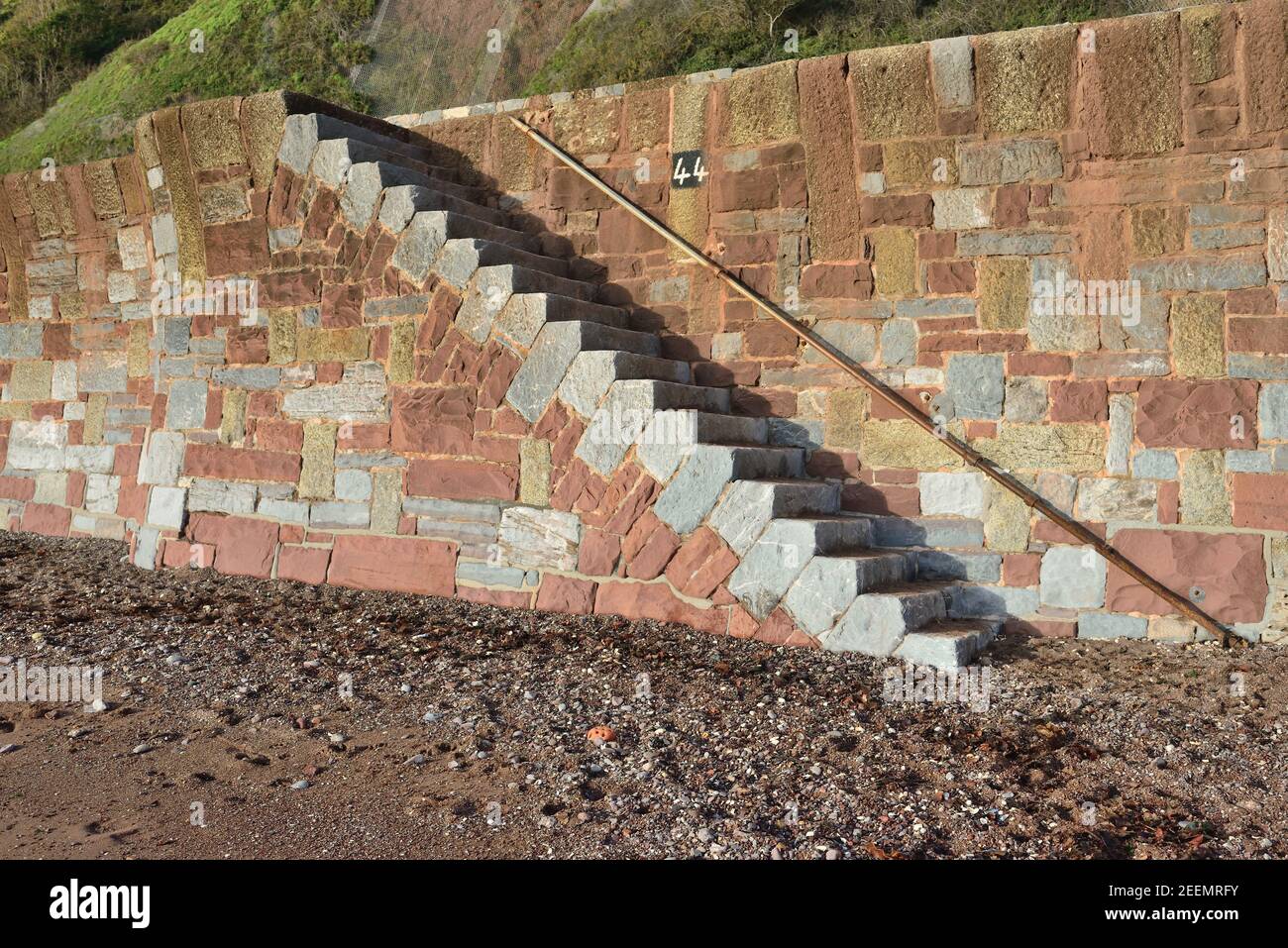 Steps in the seawall, leading up from the beach Stock Photo - Alamy