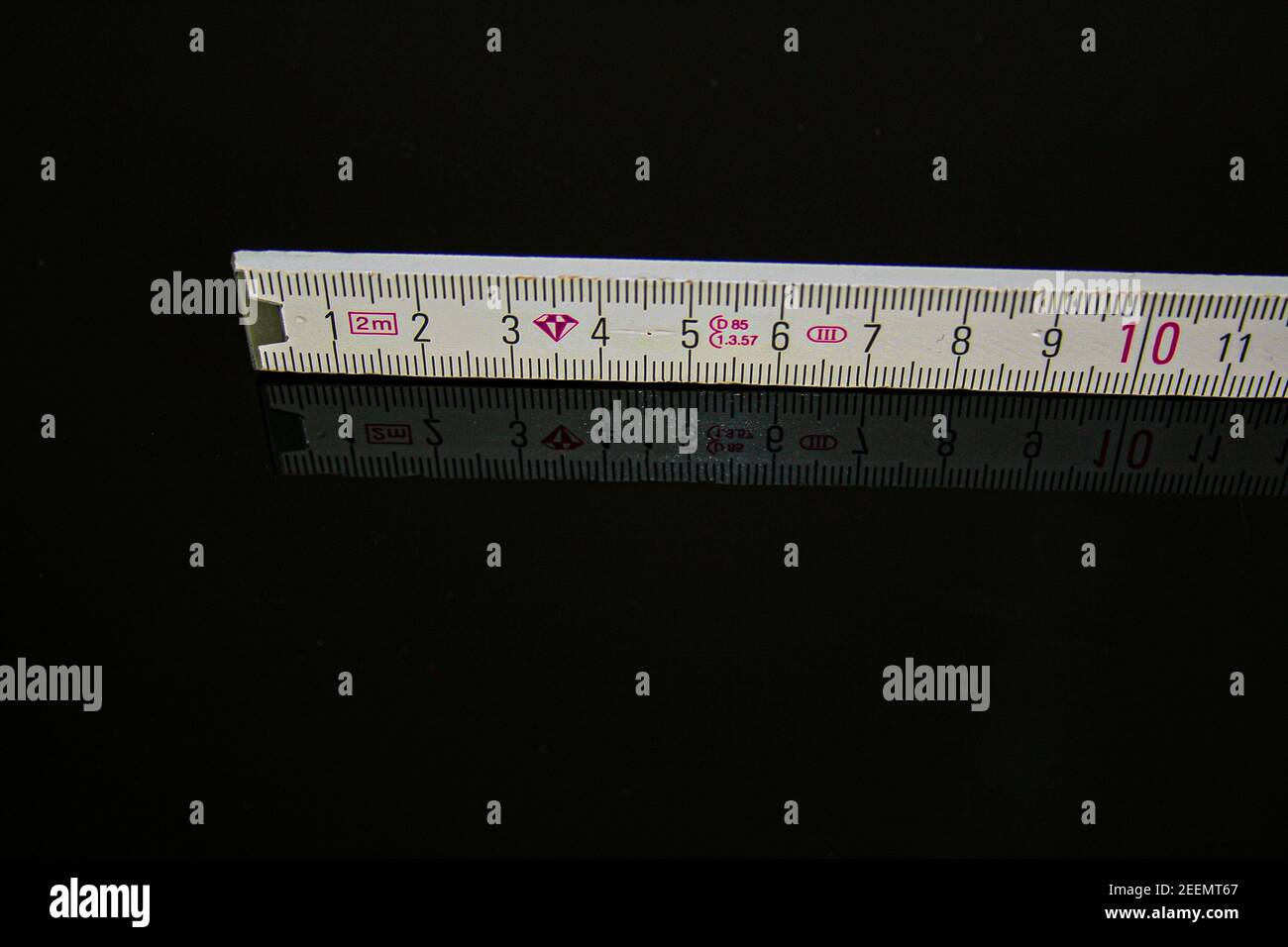 Metal measuring ruler on black back Stock Photo - Alamy