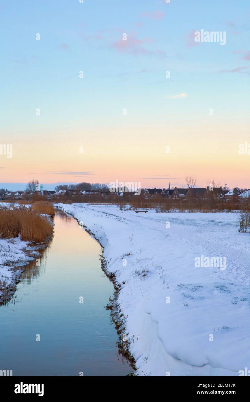Winter landscape in The Netherlands with beautiful colored sunset sky ...