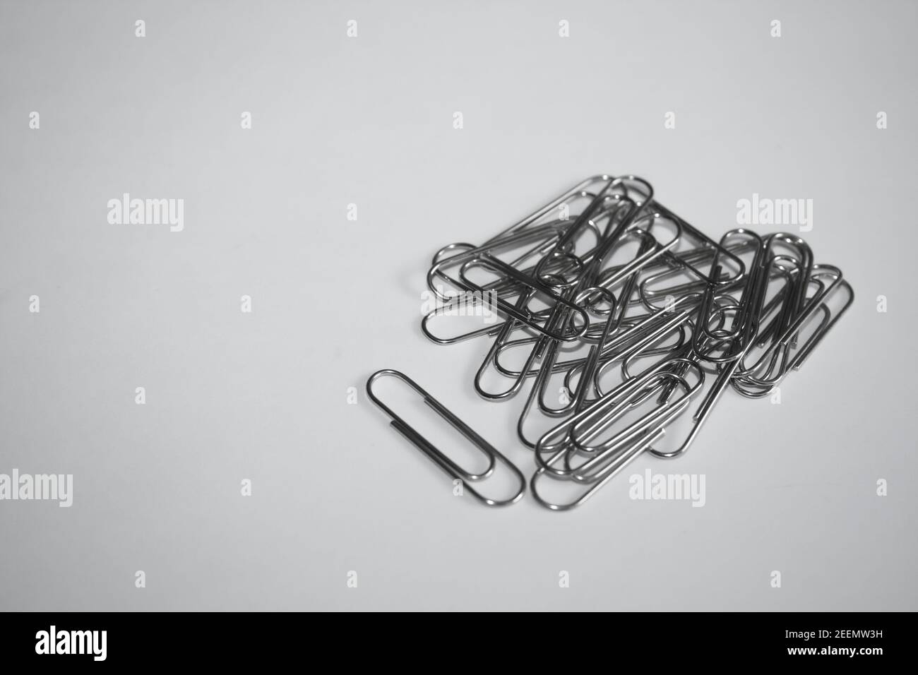 Pile of metal paper clips on white background Stock Photo - Alamy