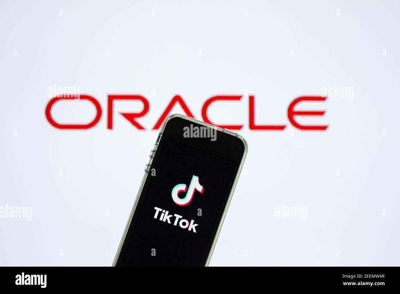 In this photo illustration, a Tik Tok app seen displayed on a smartphone with the Oracle logo in ...