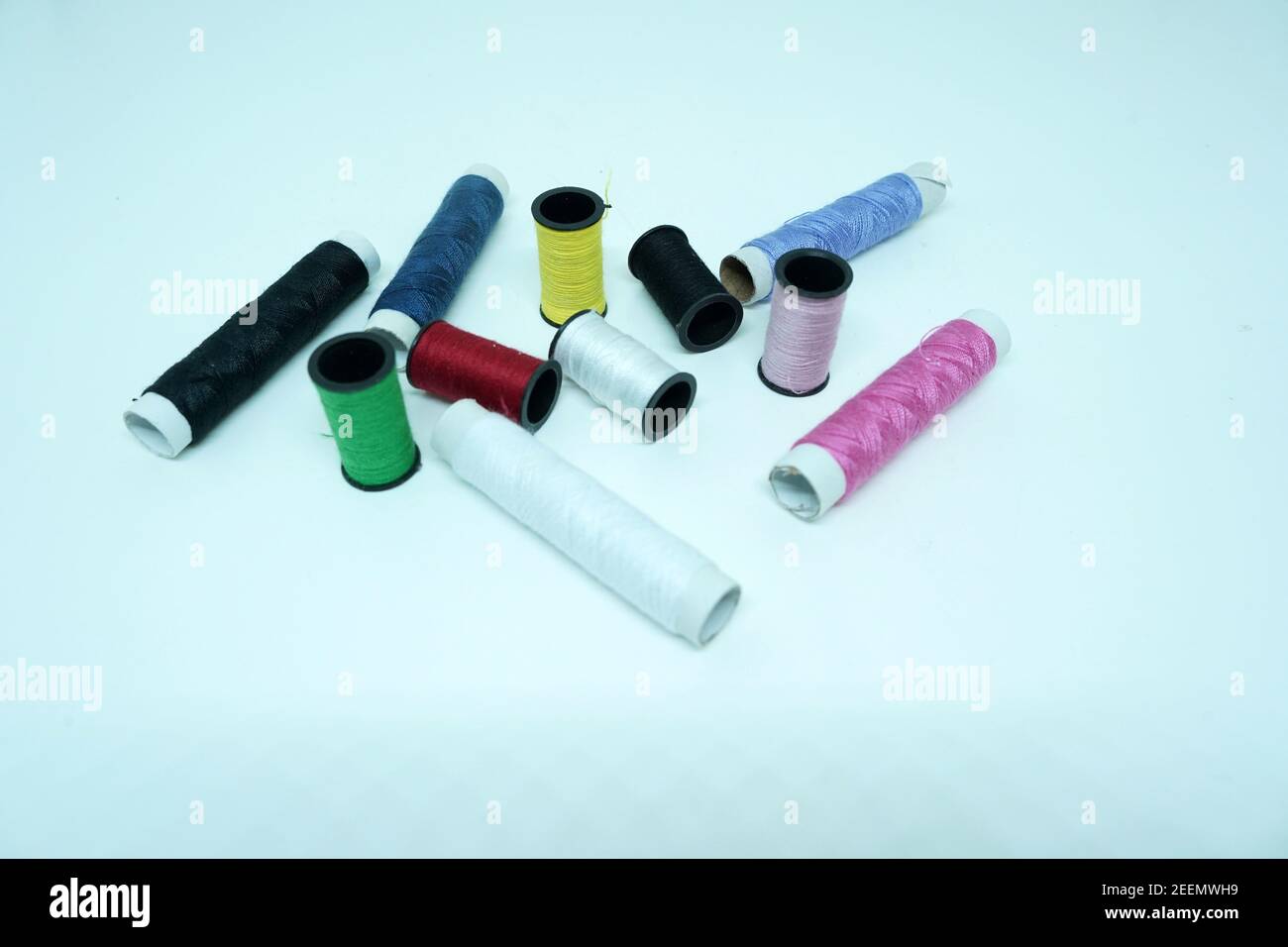 Set of colorful sewing threads on a white tab Stock Photo - Alamy